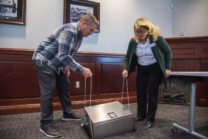 Elyria Main Branch Library lowers time capsule | Chronicle Telegram