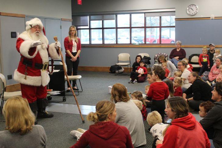 Santa visits children at the Brunswick Library for holiday event ...